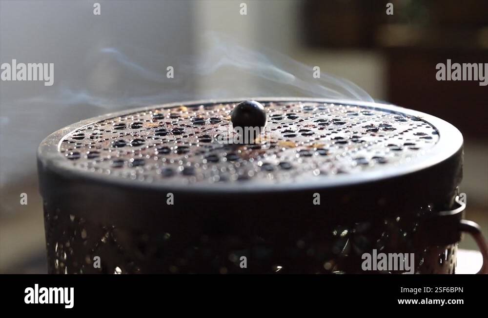 High Angled shot of Incense smoke rising out of an ornamental burner on ...