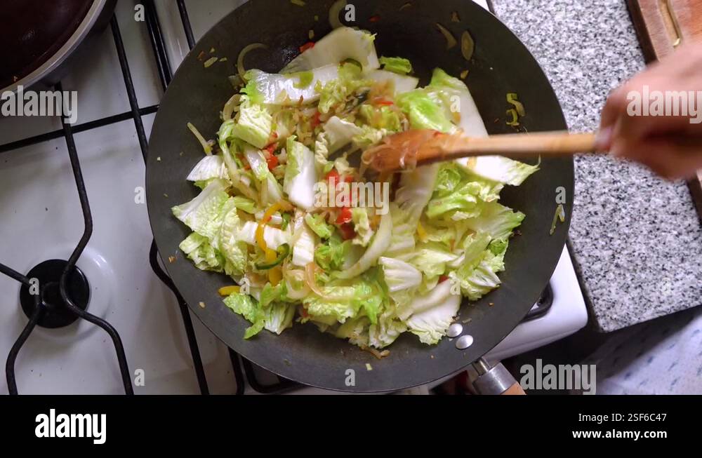 Stirring Mixed Vegetables With Napa Cabbage In A Wok Using Wooden Spoon ...