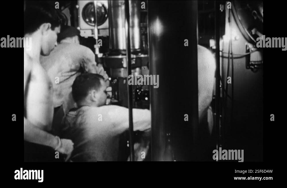 1940s: Submarine. Men work in control room. Man looks into periscope ...