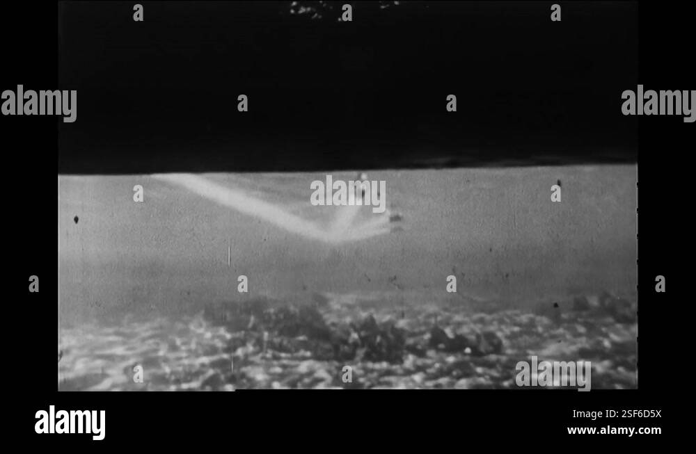 1940s: Missiles approach ship underwater. Explosion. Ship burns. Smoke ...