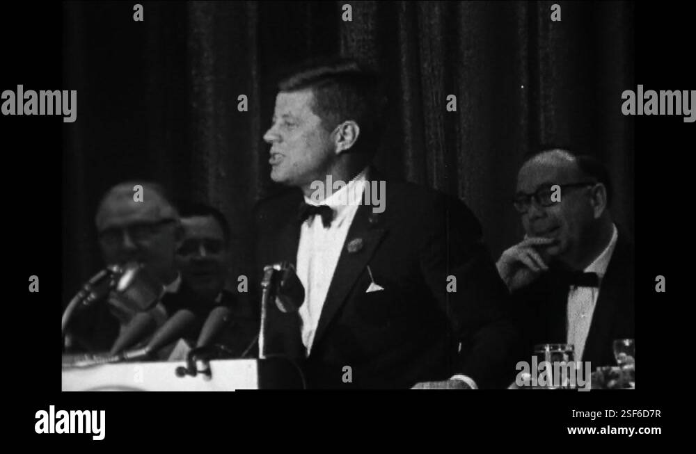 1960s: John F Kennedy speaking at podium. Couple walking up steps to ...