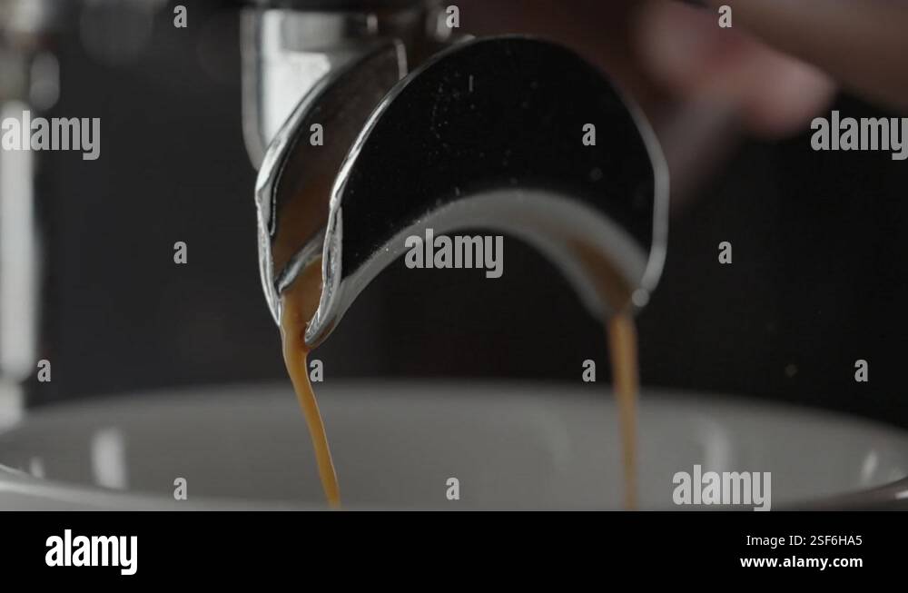 Slow motion pour double espresso with professional coffee machine Stock ...