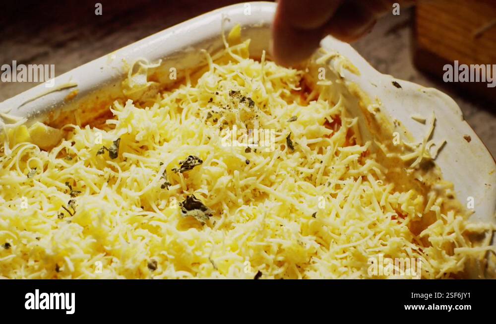Sprinkling aromatic basil mint over parmigiano Reggiano cheese in ...
