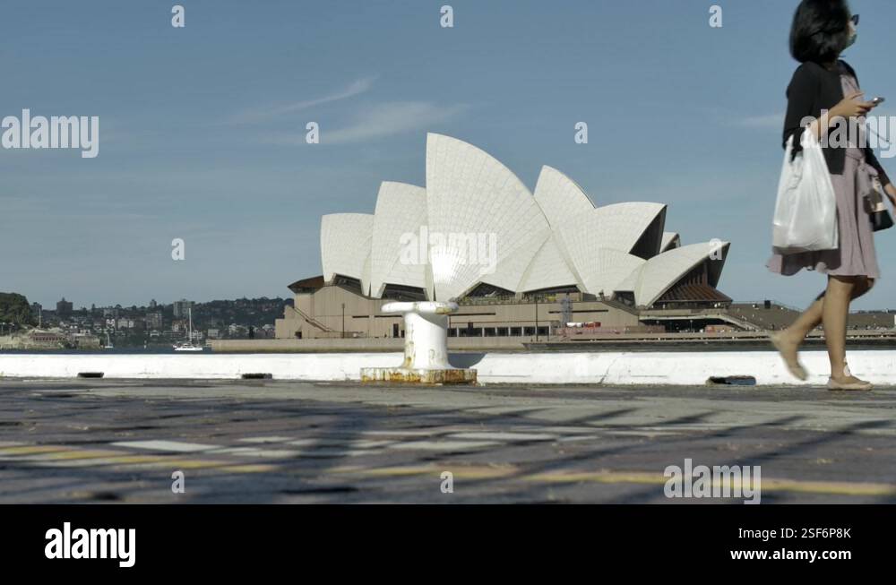 Masked woman passes Sydney Opera House slow motion 4K Stock Video ...
