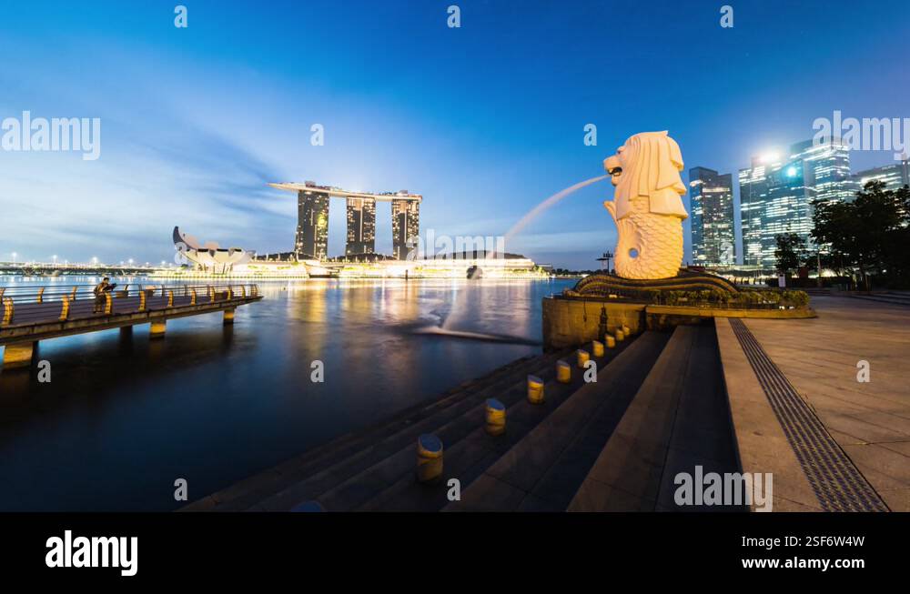 Night to day time-lapse of tourist people walk at Merlion statue ...