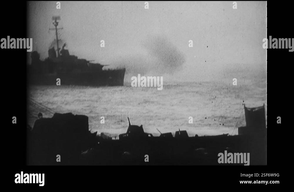 1940s: US Navy ship off-shore fires large guns. Large explosions on ...