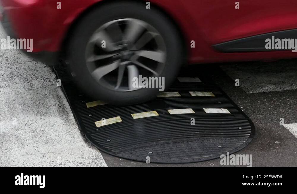 Wheels of the vehicles going over road hump on the street Stock Video ...