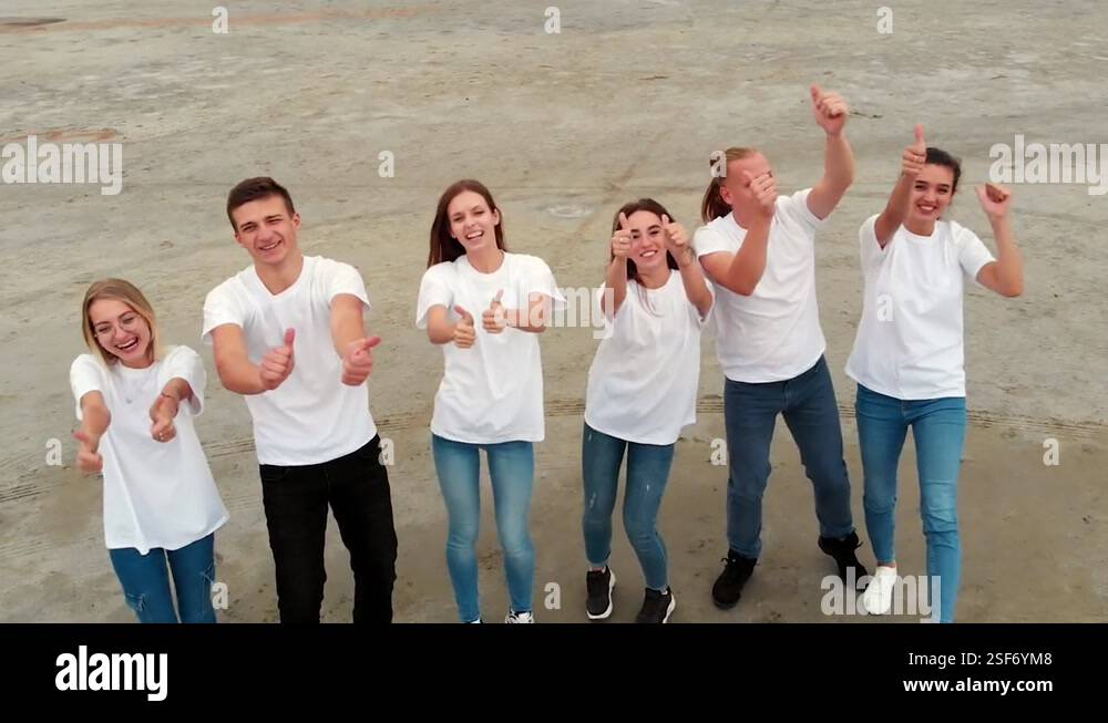 Men and women show thumbs-up and dance smiling broadly Stock Video ...
