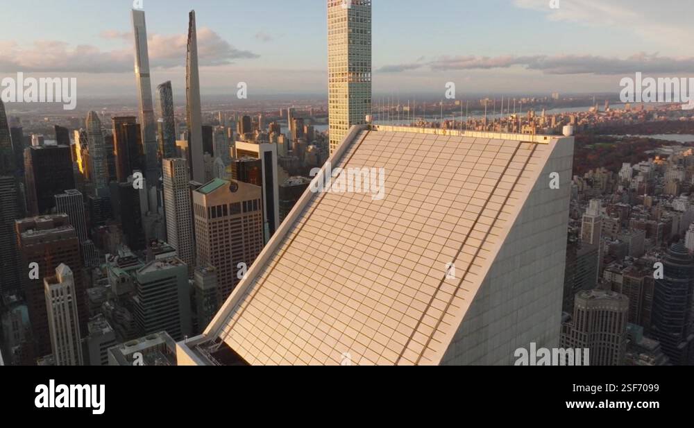 Ascending tilt down view of oblique roof of business skyscraper in city ...