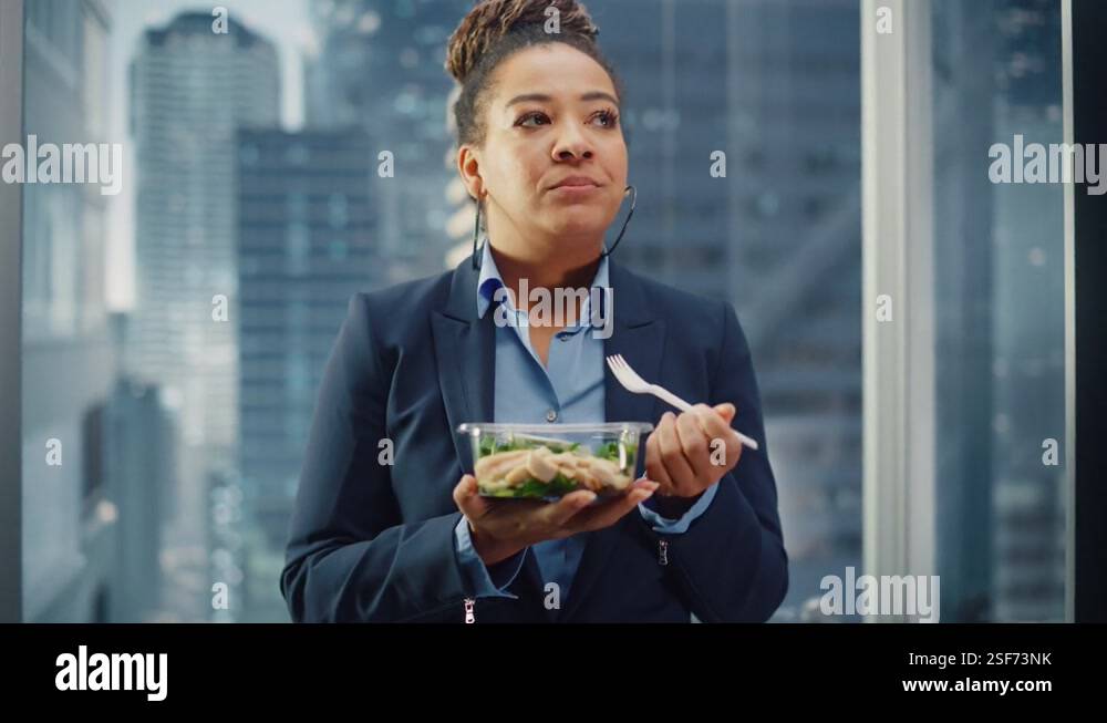 Woman Eating Salad in Elevator Stock Video Footage - Alamy