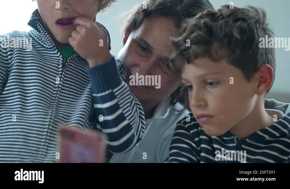 Mother and children watching phone screen together. Parent and kids ...