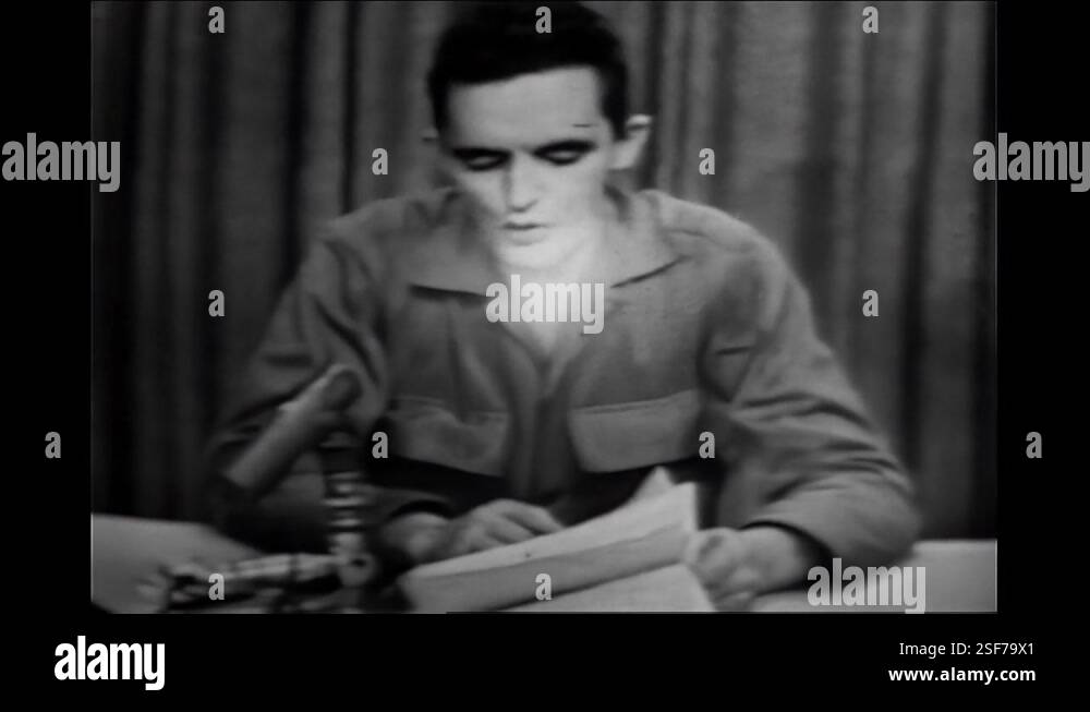 1950s: Clean shaven man in military jacket reads a speech in Spanish ...
