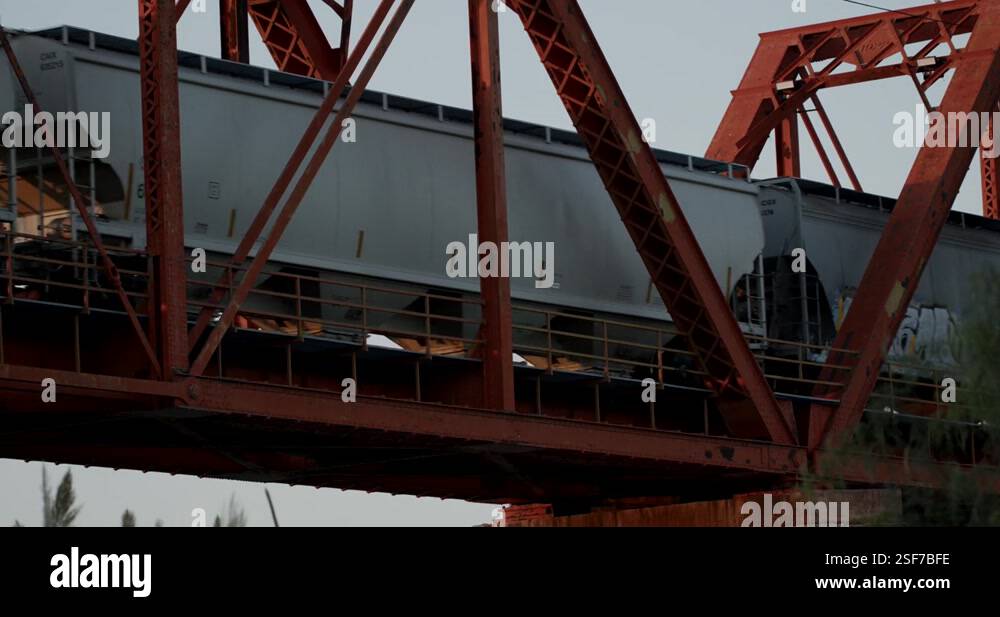 A freight train passes over the international rail bridge from Del Rio ...