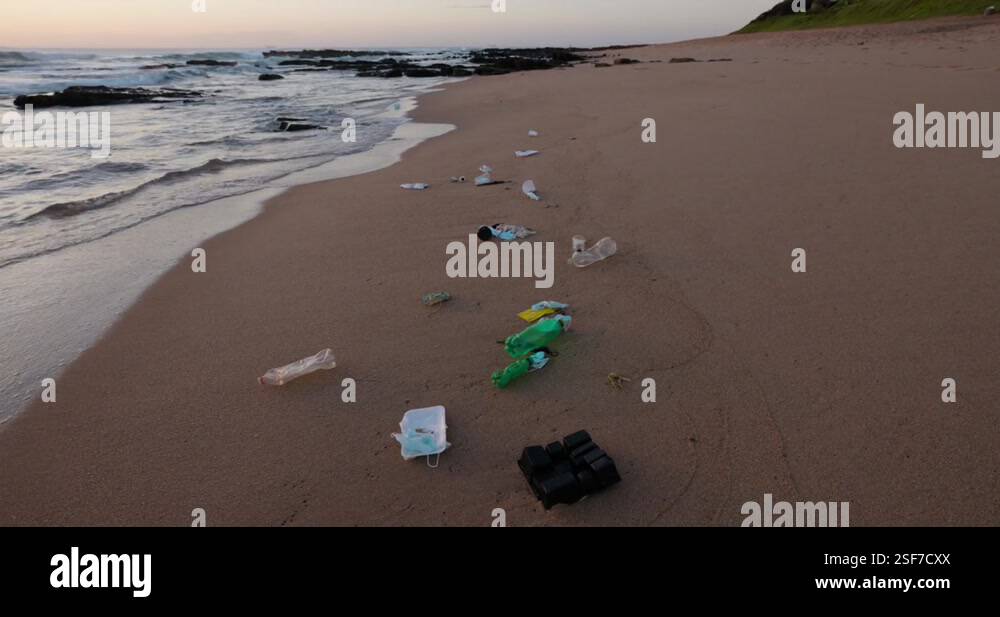 Plastic polluiton.Covid-19 protective face masks washing up and ...