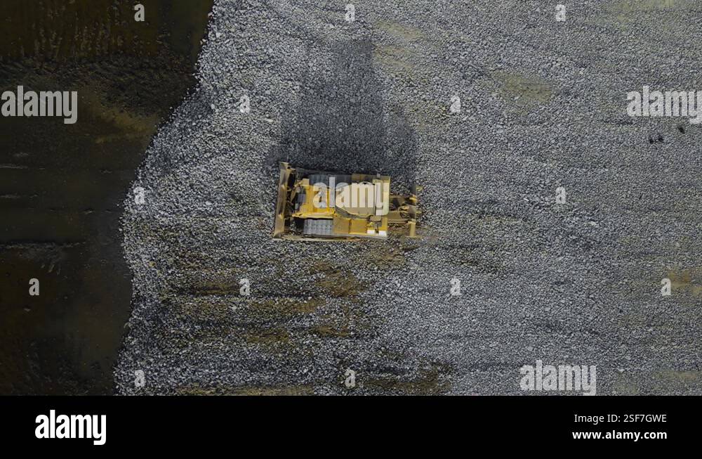 Top down view of powerful bulldozer working flattening base with ...