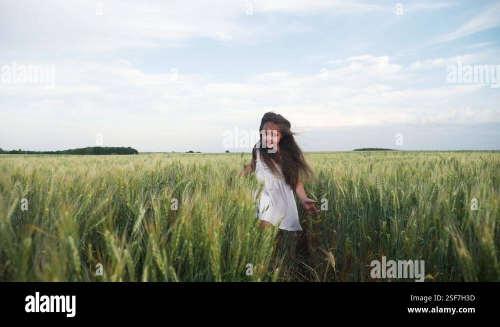 child girl running field park. girl kid run in the park wheat field at ...