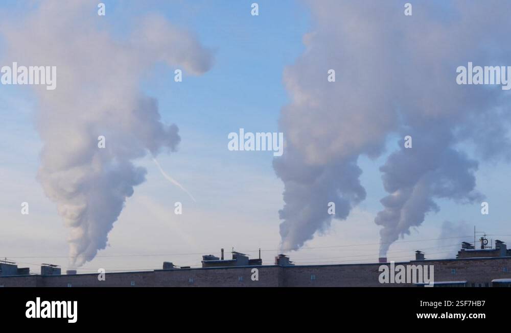 Thick smoke billows from the chimneys in the middle of the city Stock ...