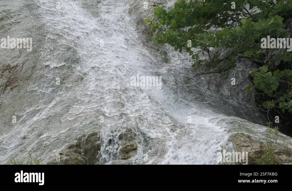 Water cascades over a sloping rock at a waterfall Stock Video Footage ...