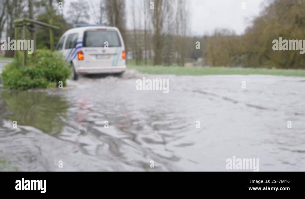 Police van driving in the flooded street after heavy rainfall. Flooding ...