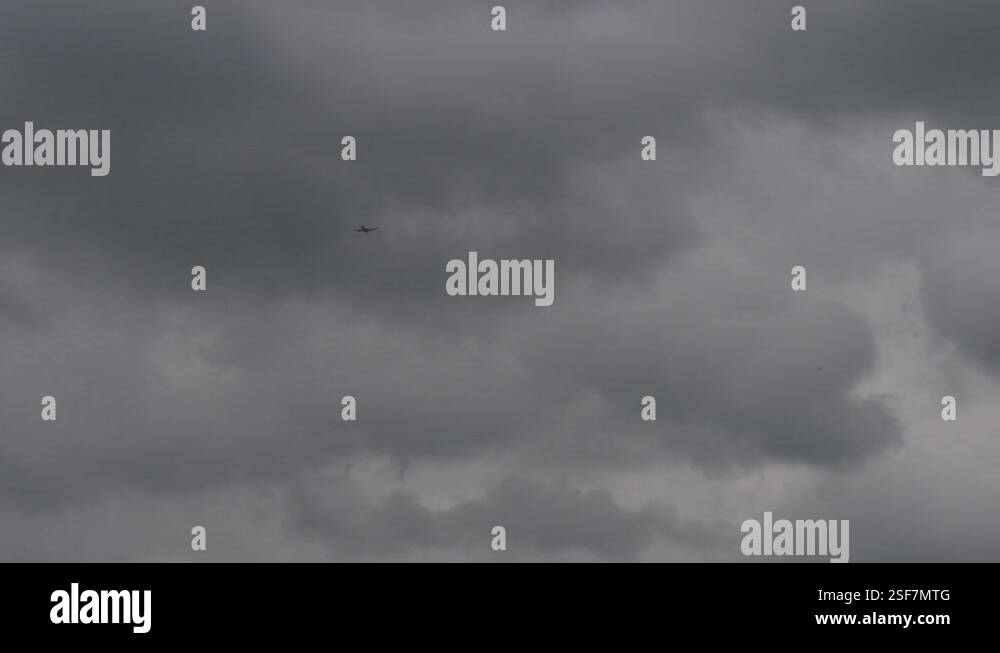 looking up at passenger jet plane flying appearing in the distance ...