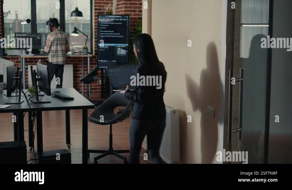 Software developer holding laptop with source code algorithm entering ... Software developer holding laptop with source code algorithm entering ...