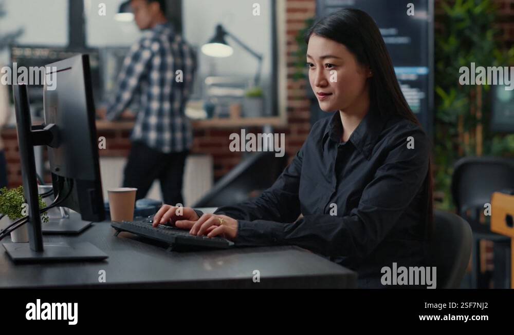 Smiling Asian Database Software Developer Writing Programming Code On Computer Stock Video