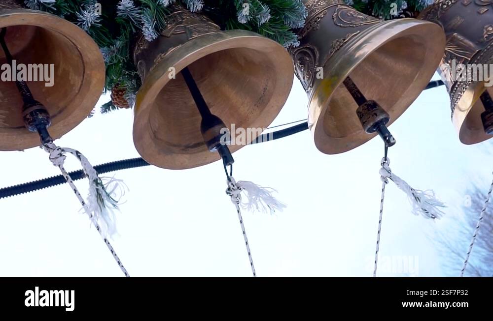 hanging bronze bells with ropes tied to them. holiday theme. close-up ...