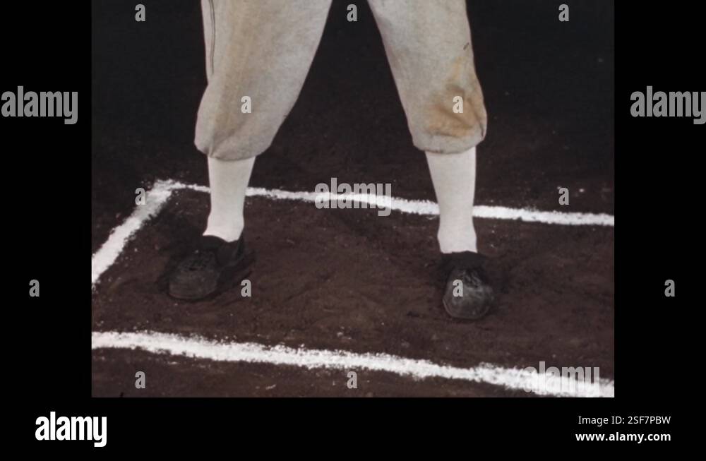 1940s: Clapboard. Baseball player's feet at plate, player swinging bat ...