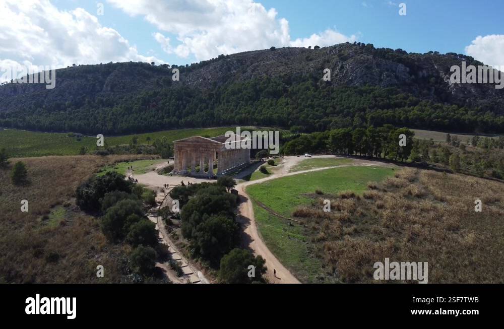 Fly-in Aerial of an Ancient Greek Temple and its Lush Landscape on a ...