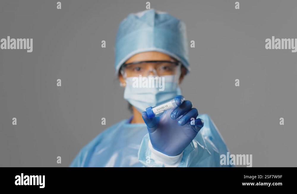 Female Lab Research Worker Wearing PPE Holding Test Tube Labelled Covid ...