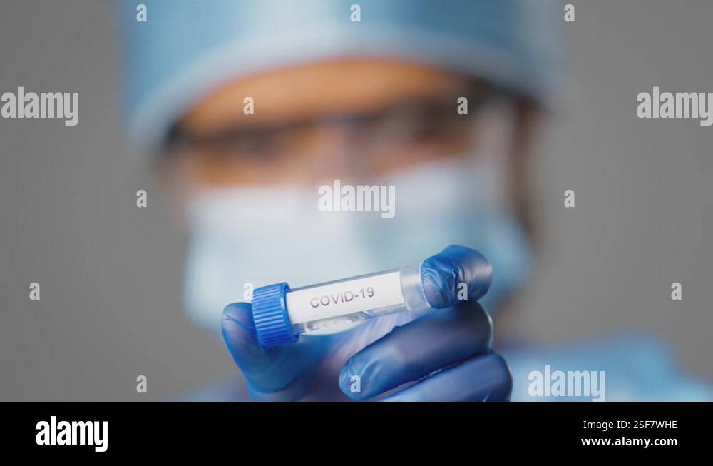 Close Up Of Female Lab Research Worker Wearing PPE Holding Test Tube ...