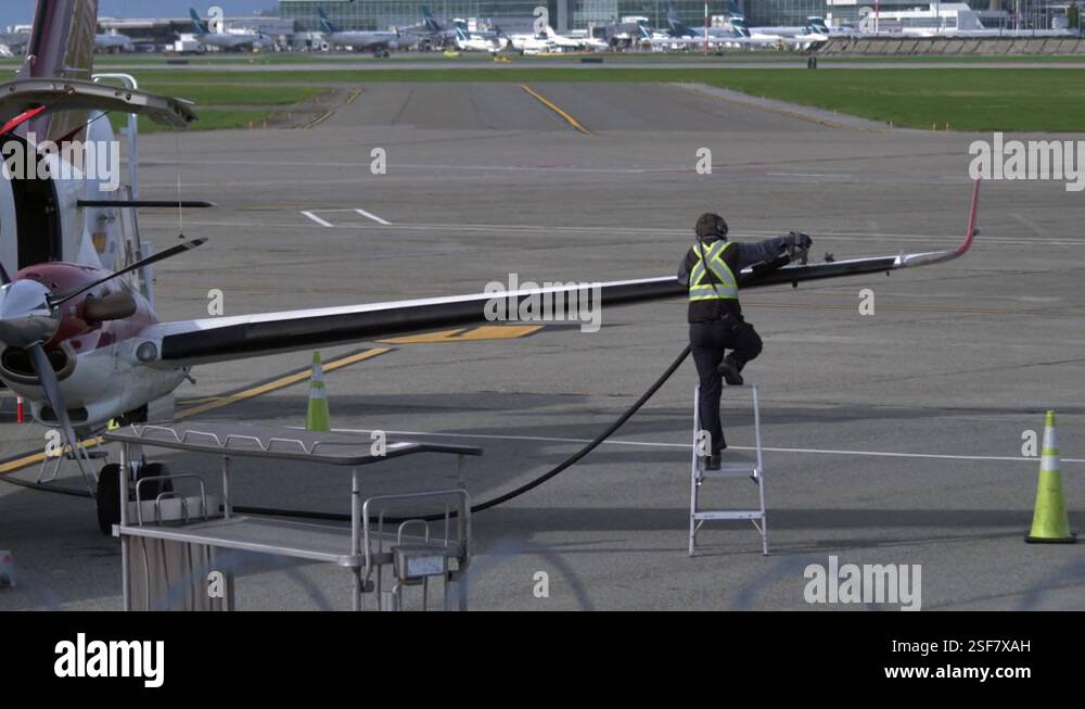 Ground Crew Overwing Fueling Turboprop Beech 1900 at Airport, Pan Stock ...