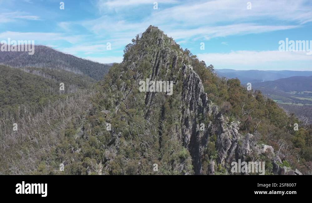Aerial flies to knife edge summit ridge of Sugarloaf peak in Australia ...
