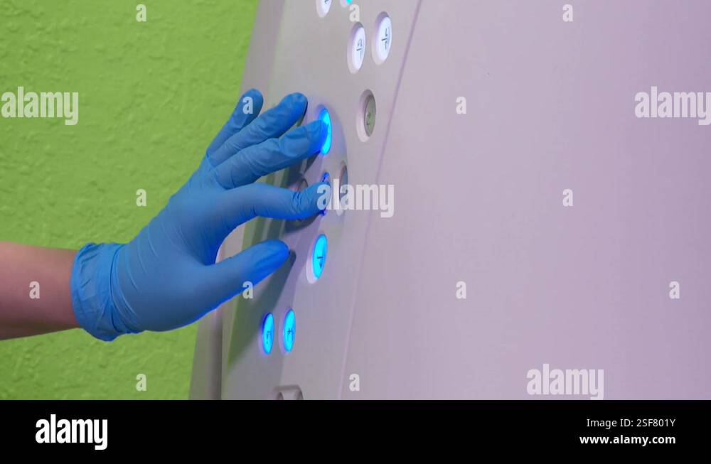 Pressing button on digital console panel on automatic mri tomography ...