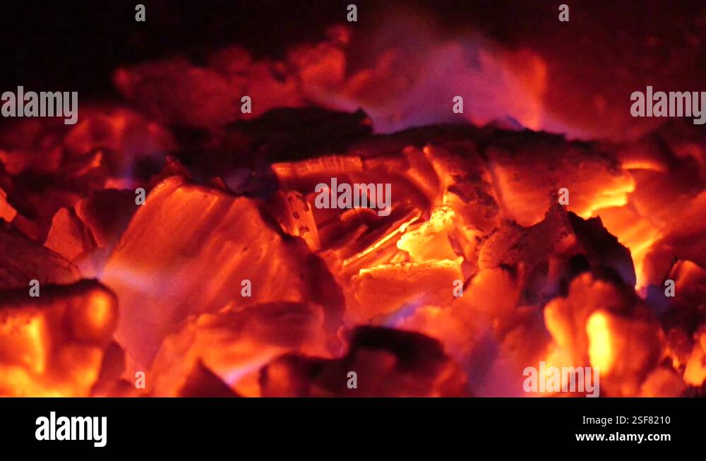 Firewood coal closeup in the fireplace. the flickering light of coals ...