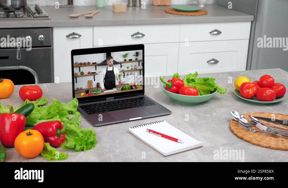 Laptop computer with man chef food blogger in screen tells teaches ...