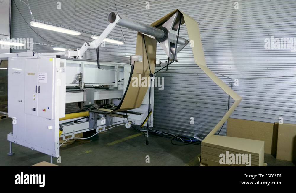 Slitting machine carves cardboard boxes from sheets of cardboard. 4K ...