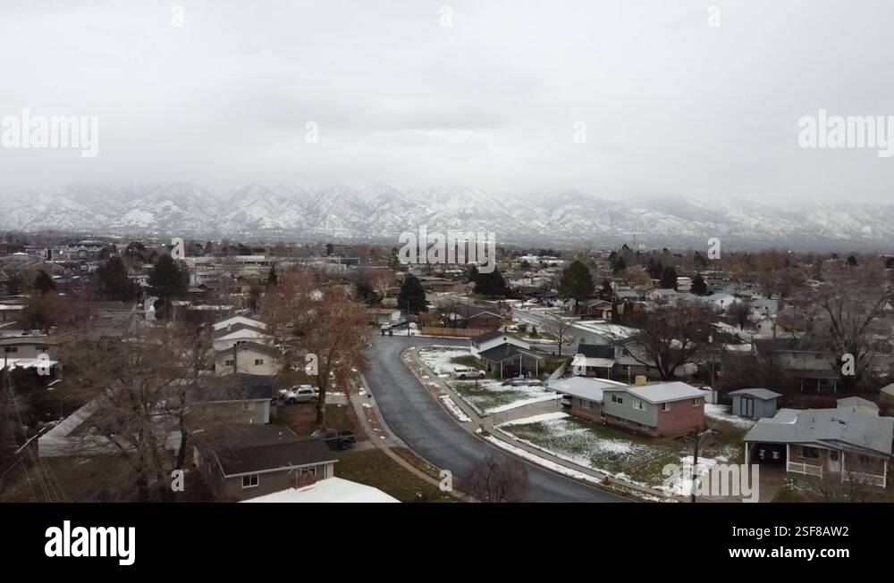 An aerial drone shot tracking backwards over a residential area, in the ...