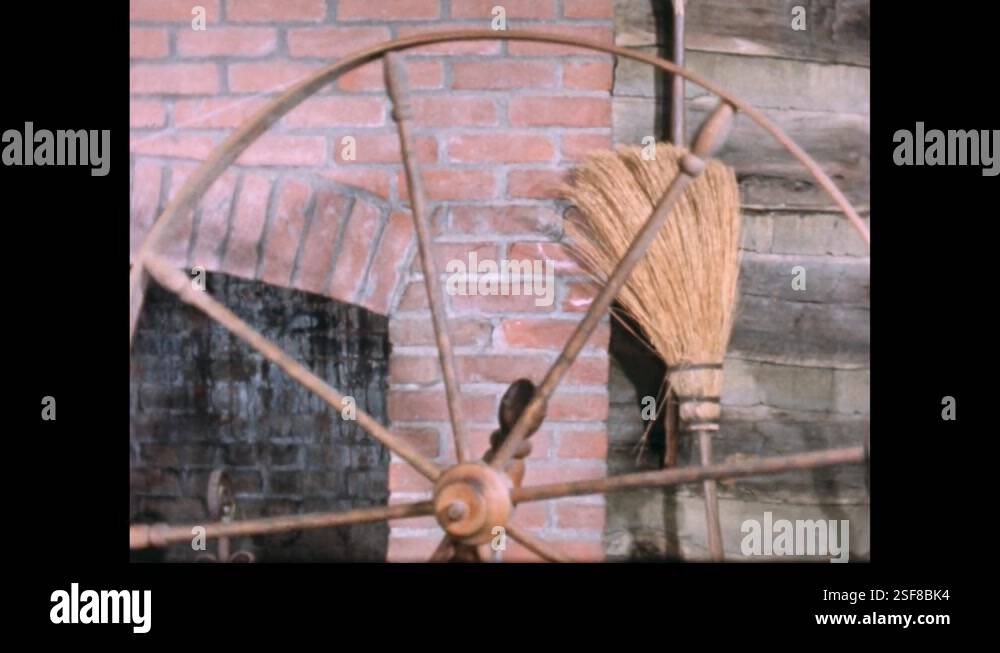 1800s: Spinning wheel slowly spinning, fabrics set down in front. Man ...
