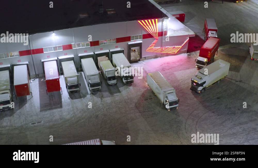 Semi-trailer truck drives up a warehouse ramp for loading and unloading ...