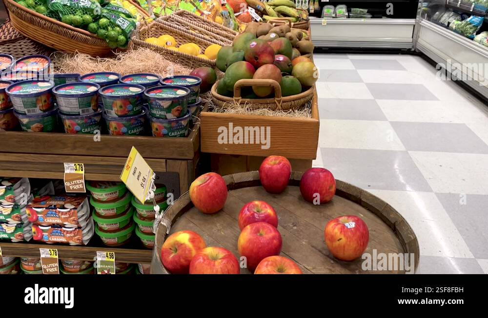 Ingles retail grocery store interior tilt of apples on a vintage barrel ...