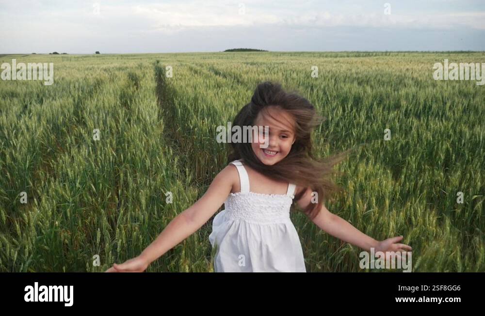 child girl running field park. girl kid run in the park wheat field at ...