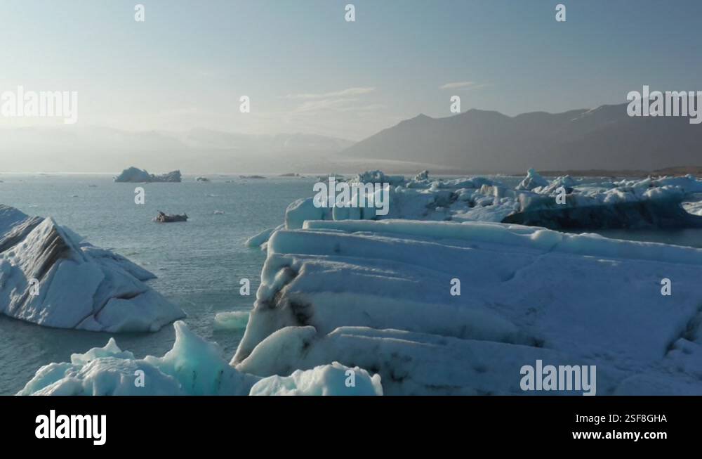 Amazing arctic landscape scenery. Backwards reveal of ice floes on lake ...