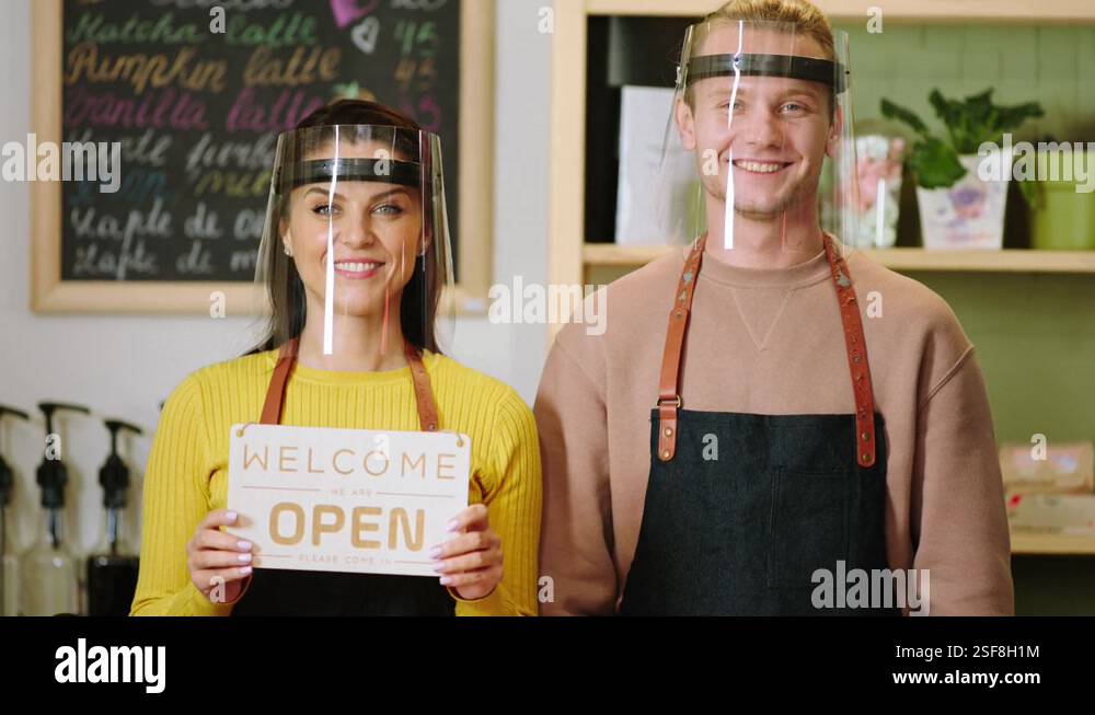 Happy two coffee shop workers barista and supervisor posing in front of ...