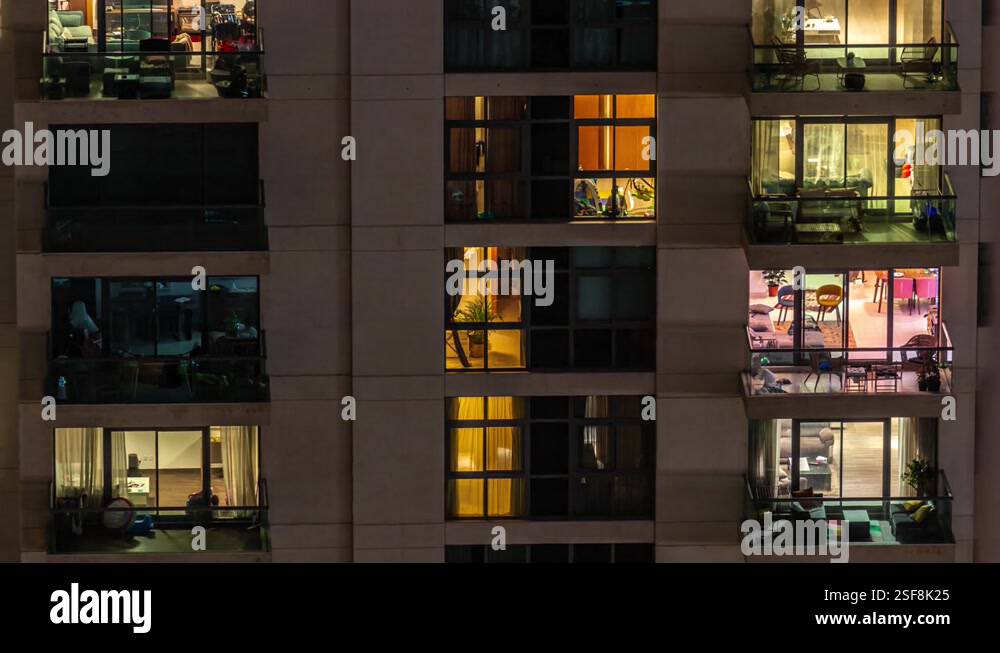 Windows of apartment building at night timelapse, the light from ...