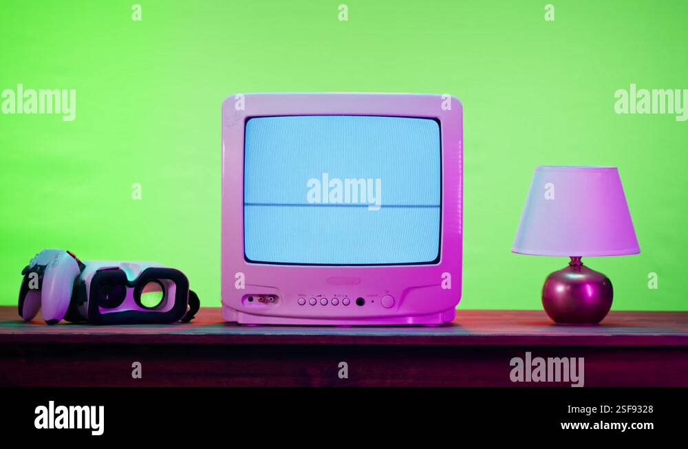 Old television with grey interference screen on green neon background ...