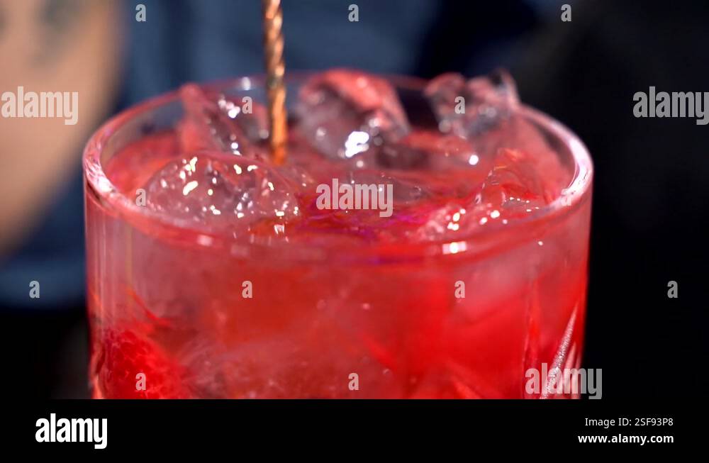 Gin mixing by female bartender in slow motion strawberries berries ...