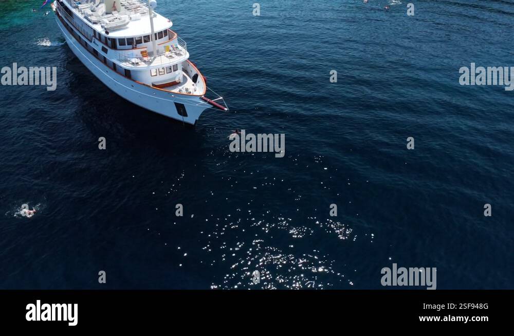 Tourists Swimming In The Blue Ocean Around The Passenger Boat At Summer ...
