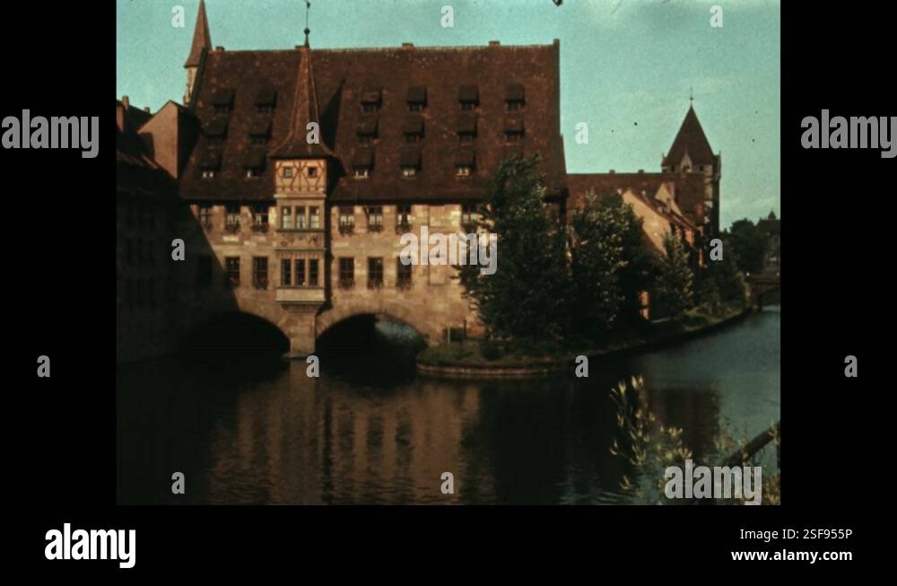 1960s: Building built over river. Building on a hill. Farm fields below ...