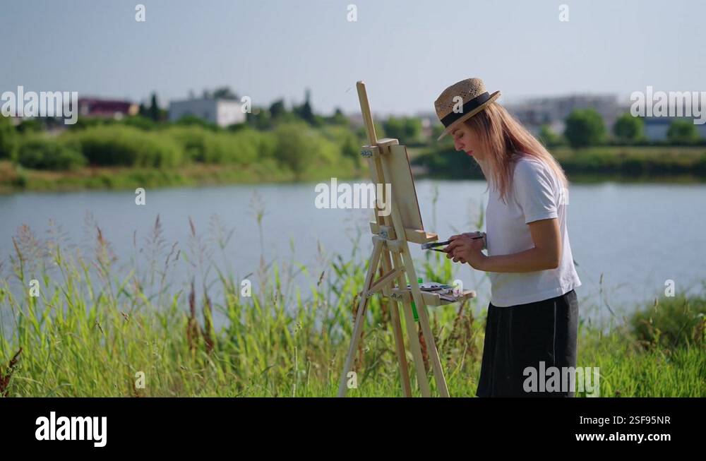 Woman artist painting on easel outdoor Stock Video Footage - Alamy